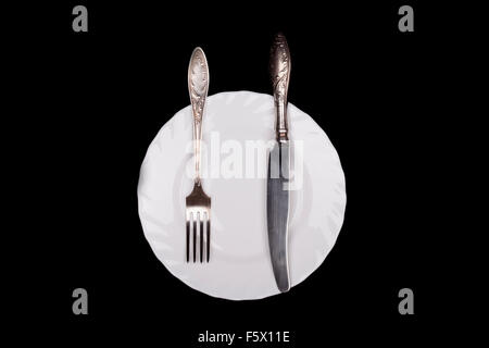 Etiquette sign. Plate, fork, knife top view isolated on black Stock ...