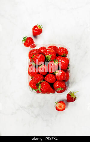 Transparent plastic tray with freshly picked ripe red strawberries ...