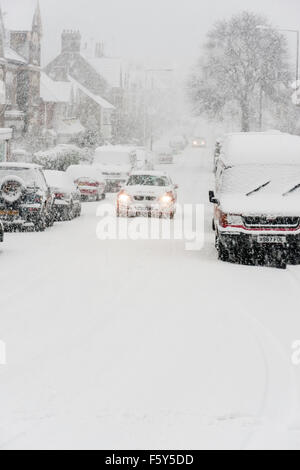 English street in Ramsgate. Heavy snow storm with snow falling and cars ...