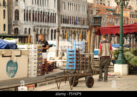 Guys using trolleys and carts to distribute goods to Café's and ...