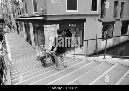 Guys using trolleys and carts to distribute goods to Café's and ...