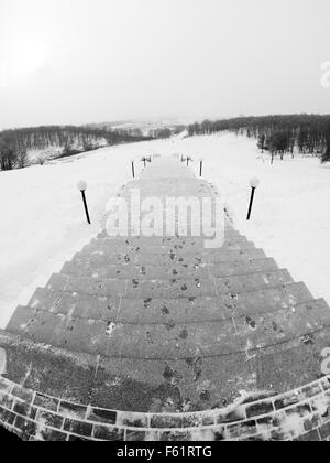 Long steps way down to valley at winter day Stock Photo - Alamy