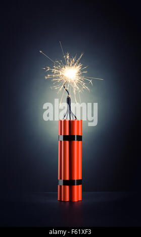 Dynamite pack with burning wick Stock Photo - Alamy