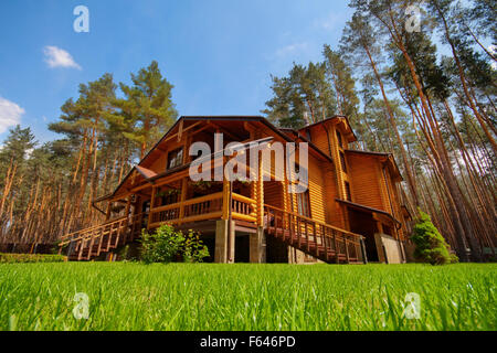 Big wooden mansion in pine forest Stock Photo - Alamy
