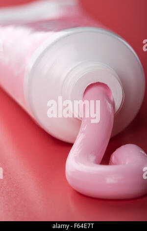Pink toothpaste squeezing out of tube Stock Photo - Alamy