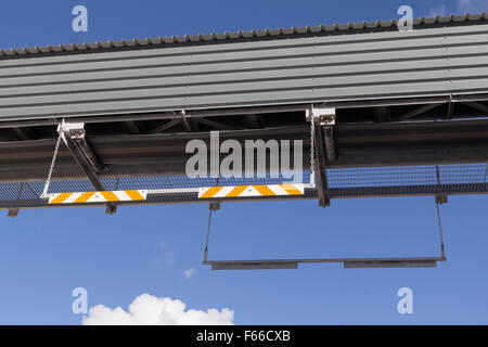 Overhead obstruction warning markers hanging below a conveyor Stock ...