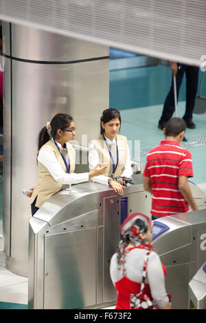 Dubai Metro station staff attending to the public Stock Photo - Alamy