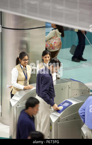 Dubai Metro station staff attending to the public Stock Photo - Alamy