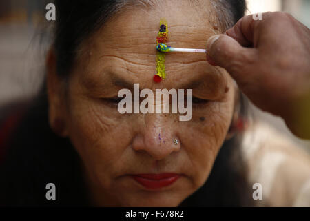 Kathmandu, Nepal. 13th Nov, 2015. A girl applies seven layers of ...