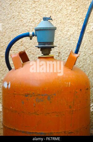 Orange gas cylinder for home use Stock Photo - Alamy