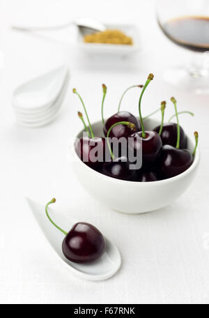 Fresh ripe cherries in spoon on wooden background. Copy space Stock ...
