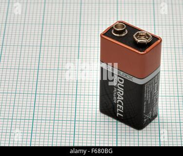 Duracell duralock 9 volt battery on a graph paper background Stock ...