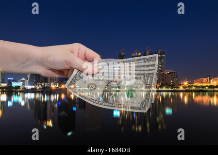 Double exposure of US dollars banknote and coins with investment chart ...