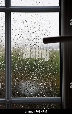 Raindrops on a glass window pane during wet weather England UK Stock ...