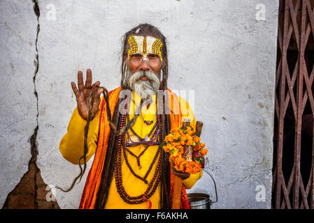 A Hindu holy man (sadhu) shows off his moustache at the sacred site ...