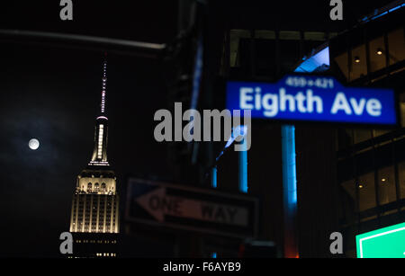 A full moon is seen next to the Empire State Building on Manhattan ...