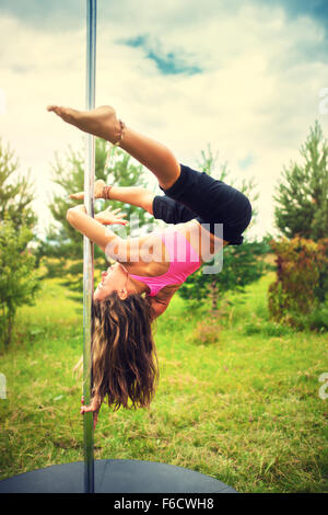 Young sexy pole dance woman on sky background Stock Photo - Alamy