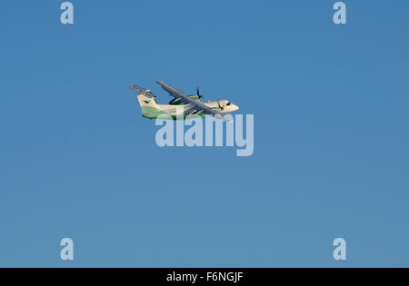 green and white propeller aircraft climbing on blue sunny sky after ...