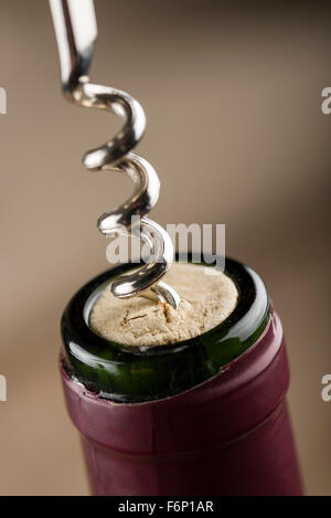 Bottle of red wine and corkscrew on a black stone background Stock ...