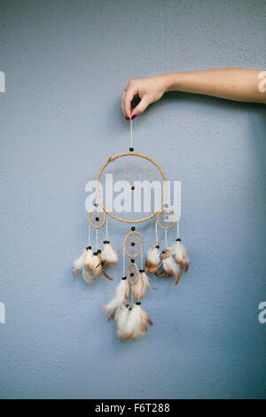A closeup shot of a female hand holding a fork with vegan macaroni and ...