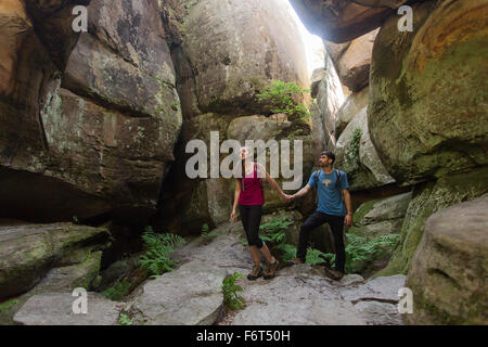 Caucasian couple exploring cave Stock Photo - Alamy