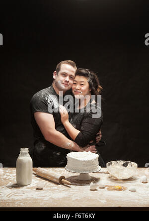 Messy couple baking cake Stock Photo - Alamy