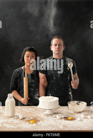 Messy couple baking cake Stock Photo - Alamy