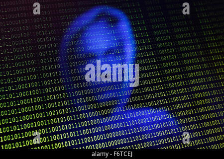 A face is reflected into a computer screen with binary type Stock Photo ...