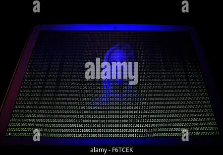 A face is reflected into a computer screen with binary type Stock Photo ...