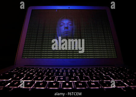 A face is reflected into a computer screen with binary type Stock Photo ...