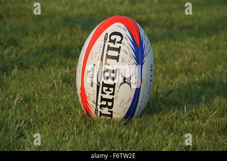 Photo of a rugby ball on a grass next to the white line, shot from ...