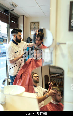 Two barbers in barber shop, one sweeping floor Stock Photo: 23765805 ...