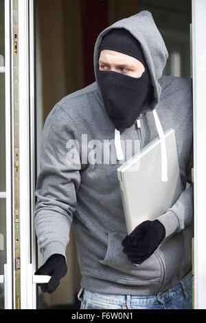 Burglar Breaking Into House And Stealing Laptop Computer Stock Photo ...