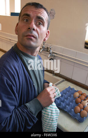 Man with disability at work at Brook Farm; Linby; tending plant in ...