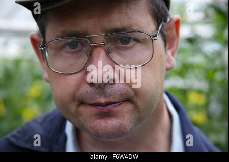 Man with disability at work at Brook Farm; Linby; tending plant in ...
