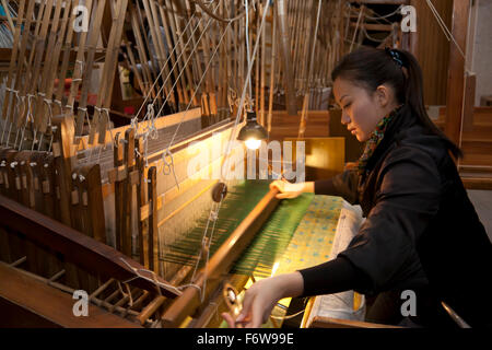 A weaver making Shu brocade fabric with a traditional loom at the Shu ...
