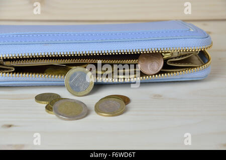 Money falling out of wallet Stock Photo - Alamy