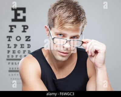 Young handsome man wearing glasses over isolated background covering ...
