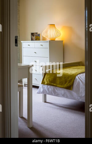 Interior of light bedroom with chest of drawers and fruit basket Stock ...