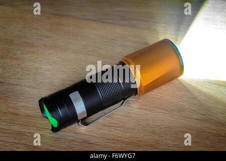 Included a small electric torch lying on the table surface. From it ...