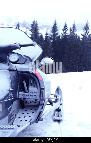 Side view of Snowmobile in winter mountains with forest Stock Photo - Alamy