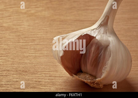 single garlic clove shot on a wooden background Stock Photo - Alamy