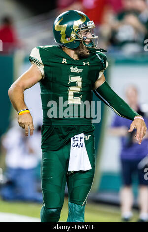 South Florida quarterback Steven Bench (2) slips a tackle by Cincinnati cornerback Jarred Evans ...