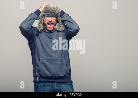 Middle-aged reacting in shock and horror with her mouth agape and hands ...