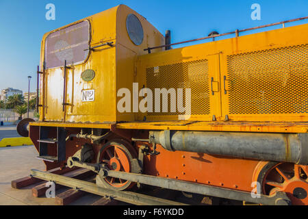 a vintage old yellow locomotive diesel engine of a train in the track ...