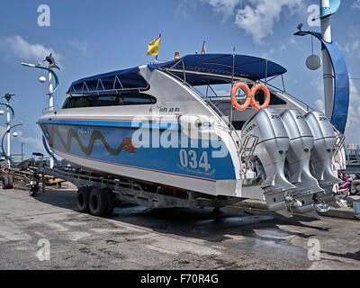 Cruise boat with triple outboard engines Stock Photo - Alamy