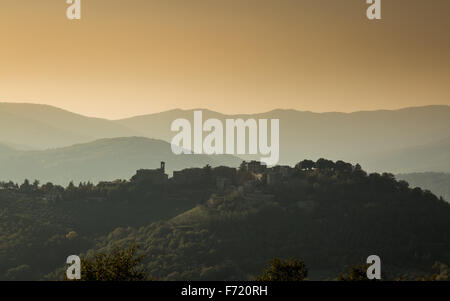 Houses and church of Hilltop village of Preggio silhouetted against the ...