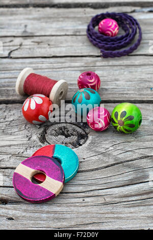 Stylish beads and spools of thread on wooden background Stock Photo - Alamy