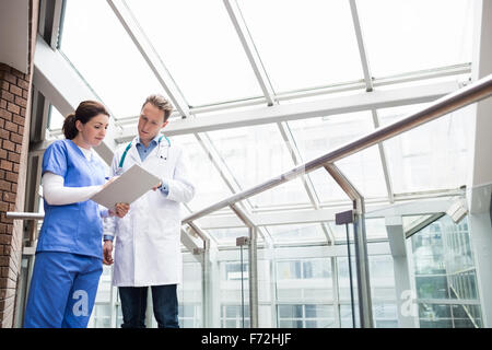 Medical team standing and talking Stock Photo - Alamy