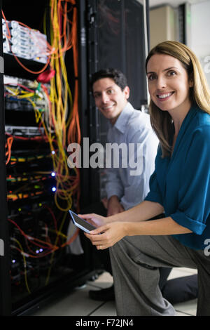 Woman working on servers with tablet pc on the phone Stock Photo - Alamy